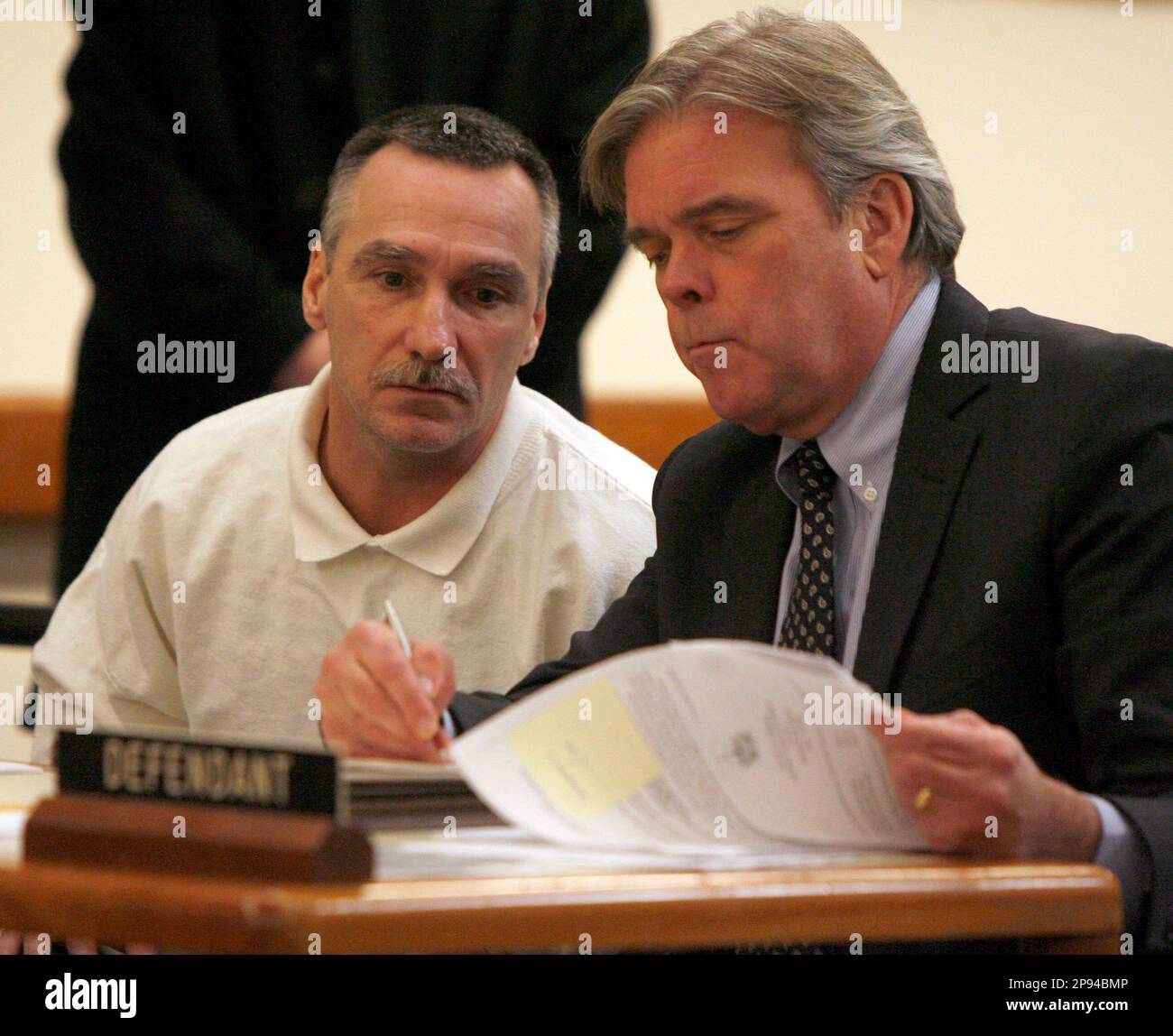 Theodore C. Caron Jr., left, confers with his attorney, David Sleigh ...