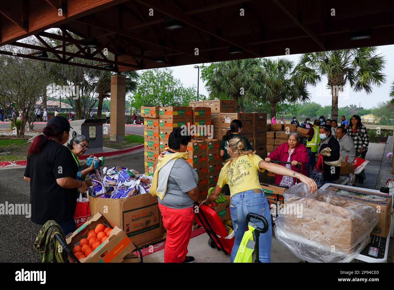 Volunteers hand out produce and nonperishable foods at the distribution ...