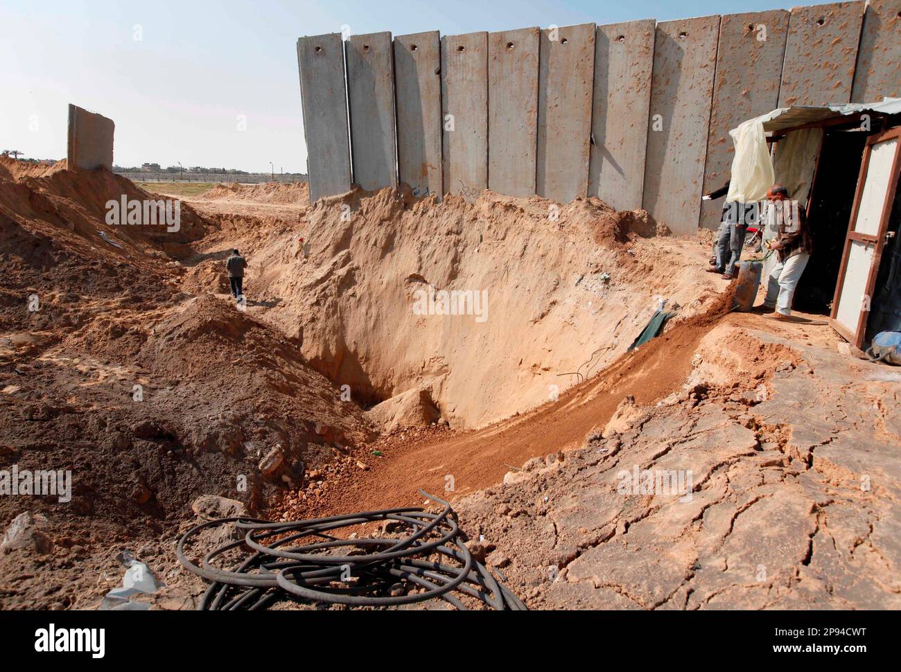 A Palestinian, right, empties a load of soil taken from a tunnel, after ...