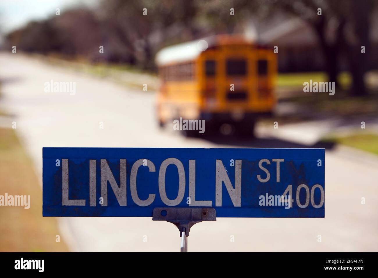 A school bus passes the street sign at the corner of Lincoln and ...