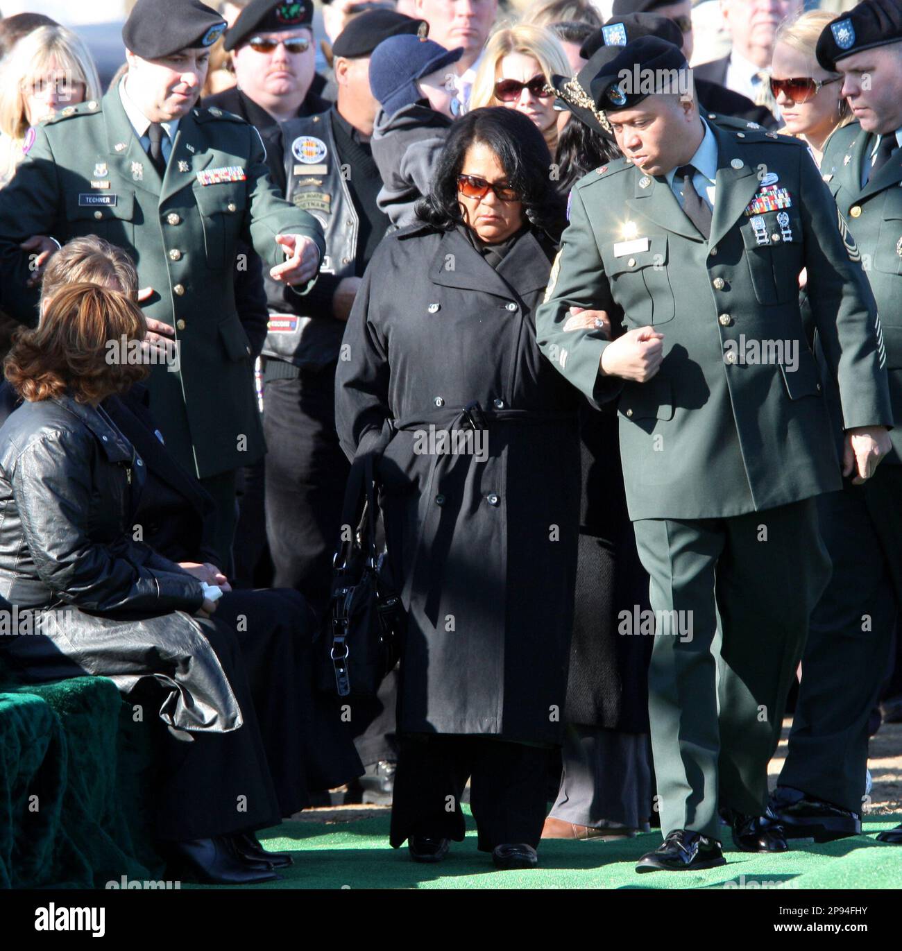 Maria Rosario Duran of New York is escorted to her seat at a burial ...