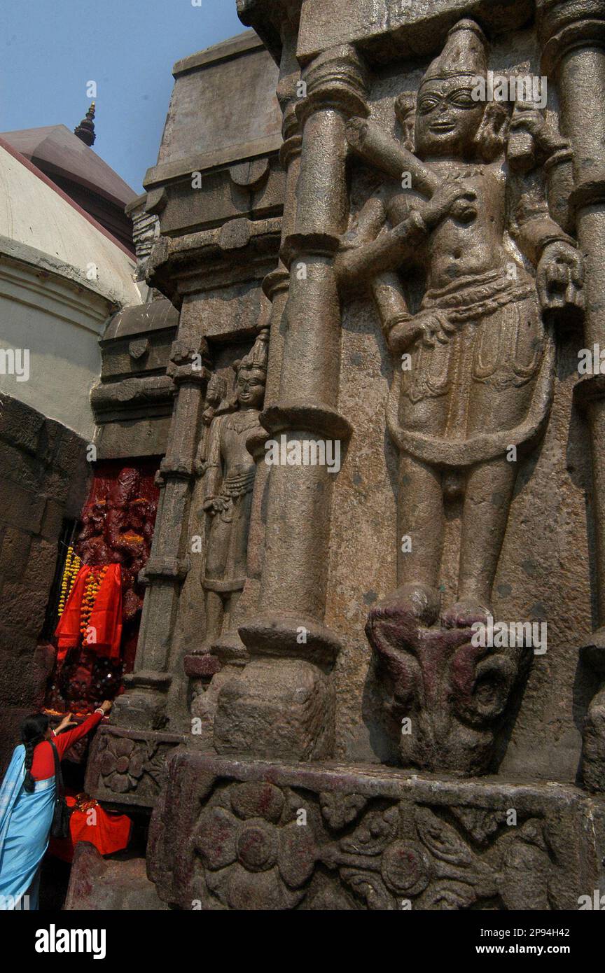 A devotee worships an idol of Hindu God Ganesha at the Kamakhya temple ...