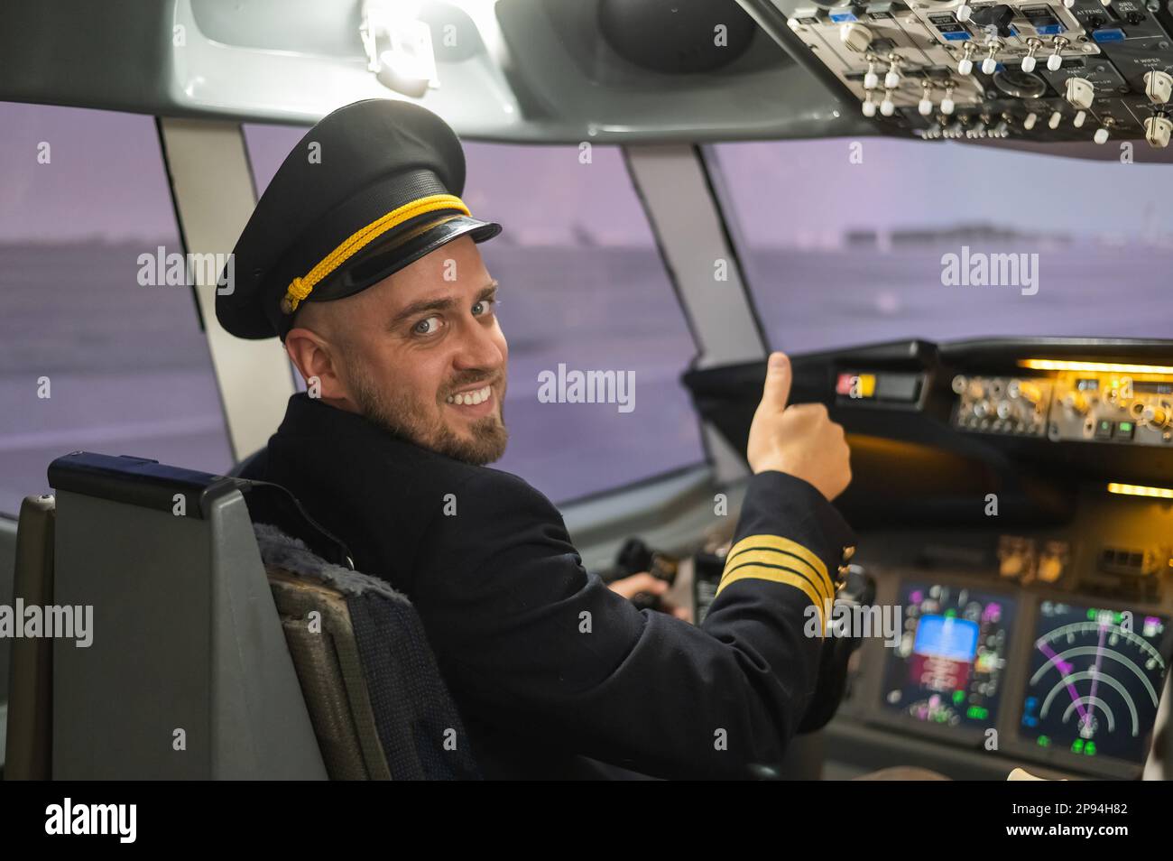 Caucasian bearded man smiling while driving a flight simulator. Pilot ...