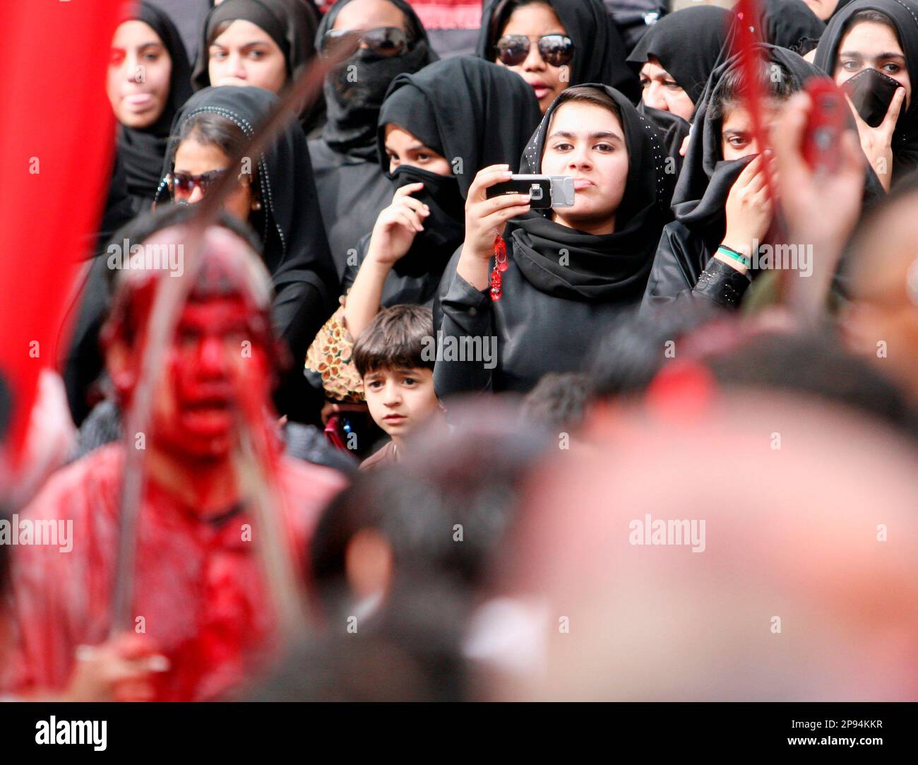 Bahraini women and children watch and take pictures Monday, Feb. 16 ...