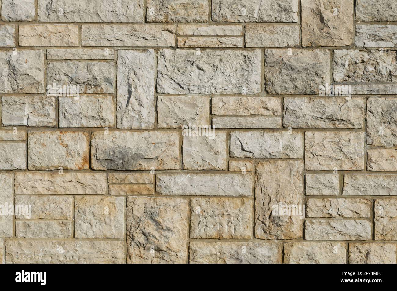 A stone wall with a symmetrical brick pattern Stock Photo - Alamy