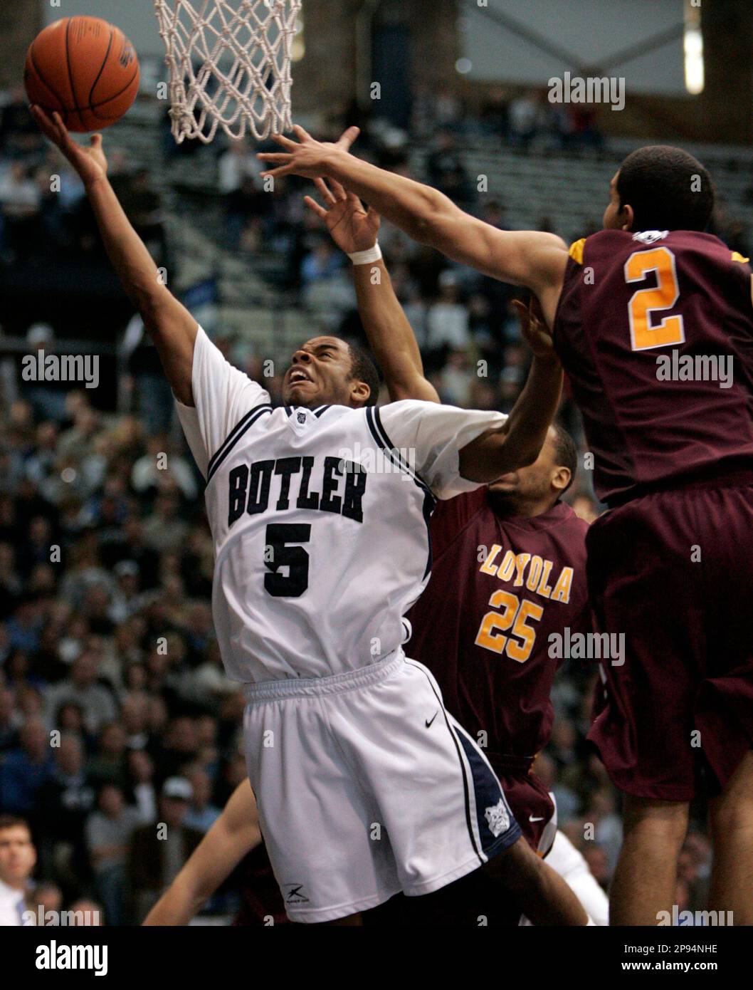 Butler guard Ronald Nored, left, is fouled by Jordan Hicks as he shoots ...