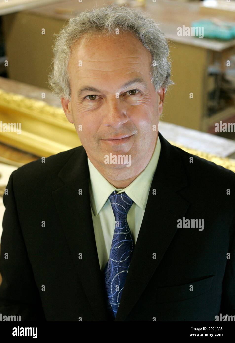 Eli Wilner poses for a portrait as workers restore a replica of the ...