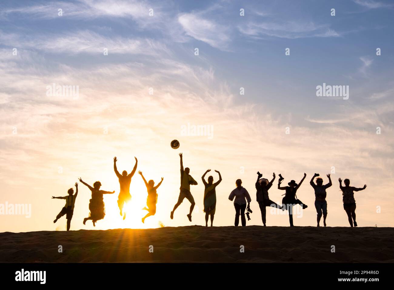 Silhouette of happy business group team over sunset sky. Success and ...