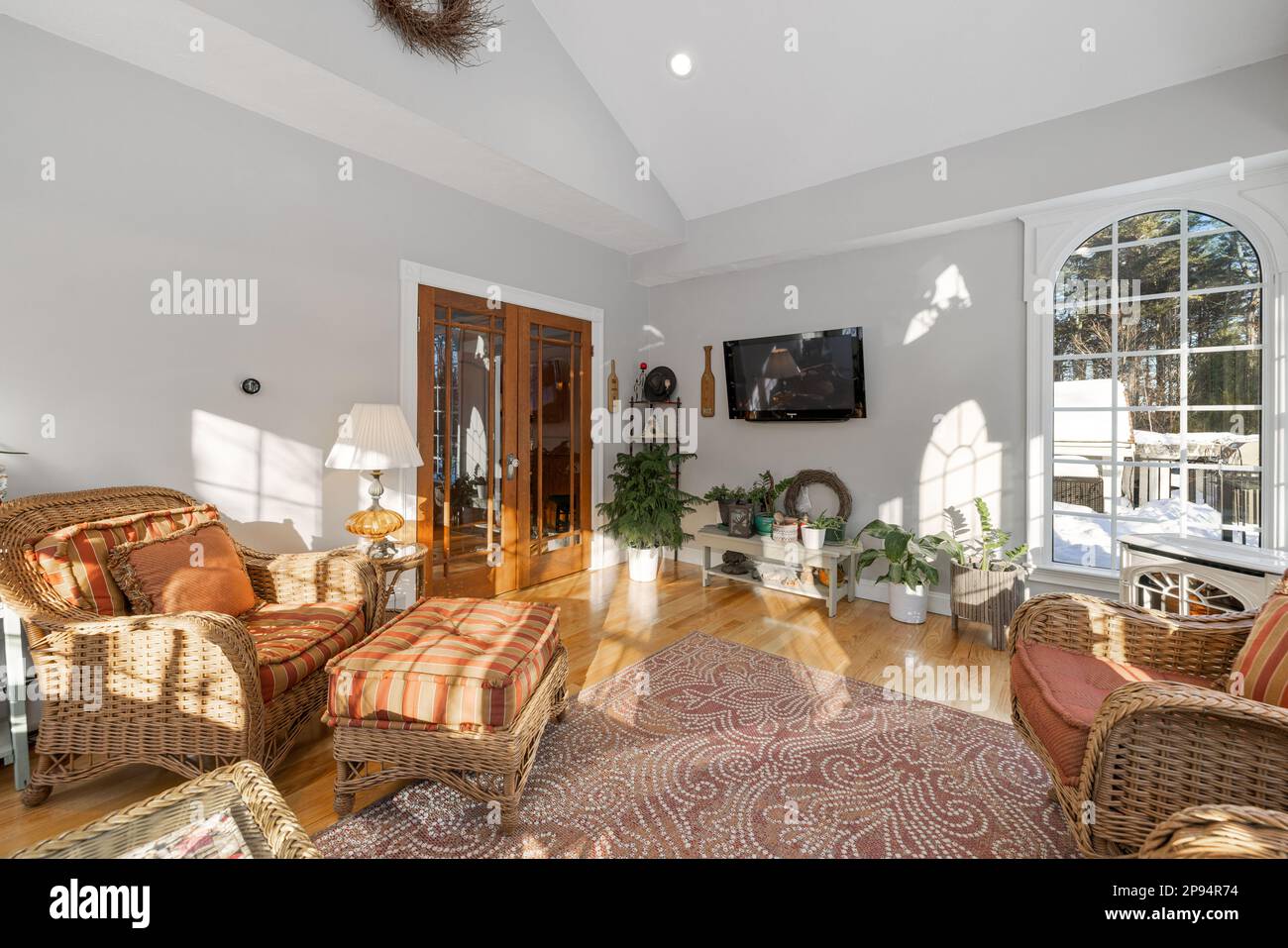 A bright living room with natural sunlight filtering in from a window ...