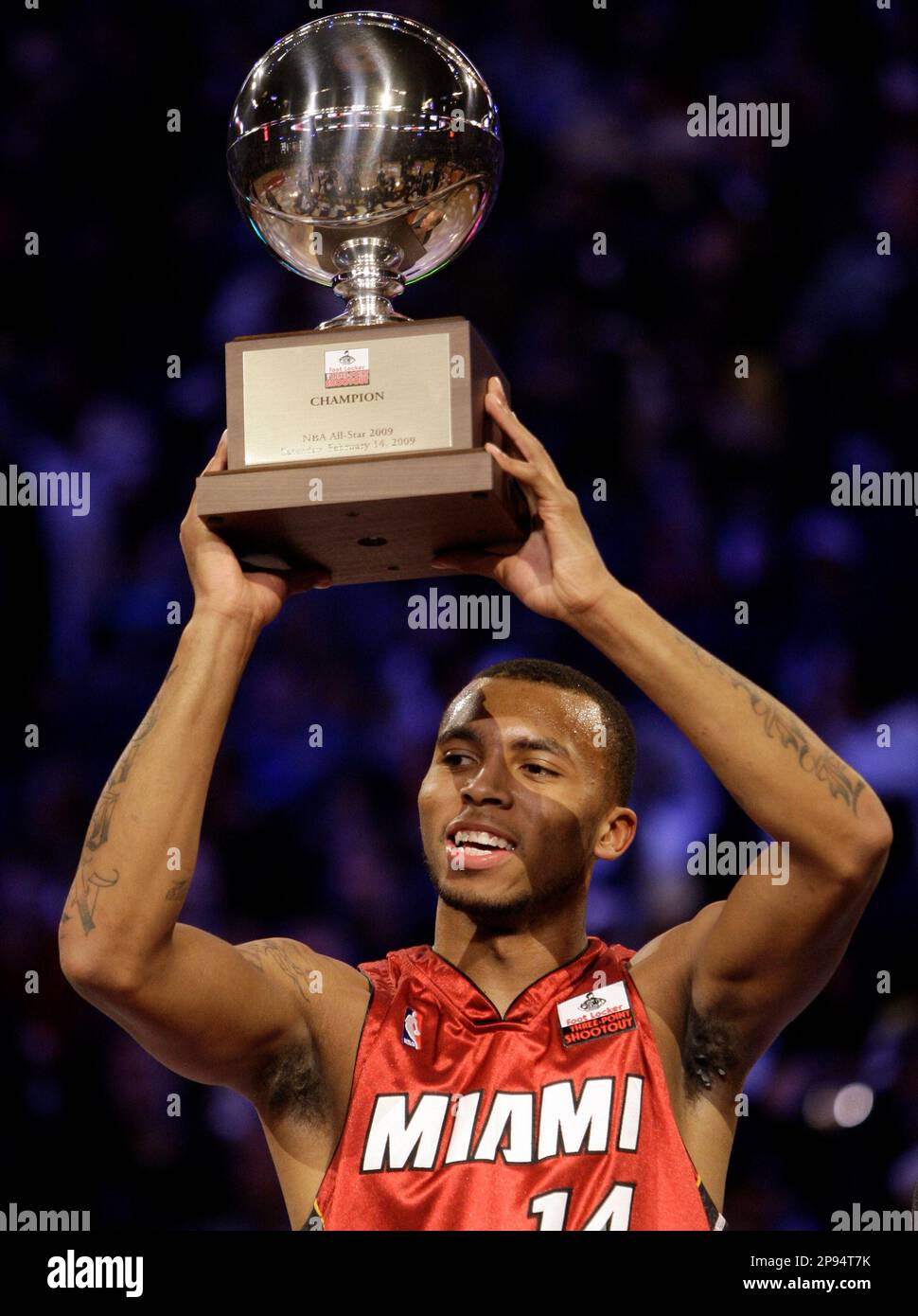 Daequan Cook of the Miami Heat displays the trophy after winning the ...