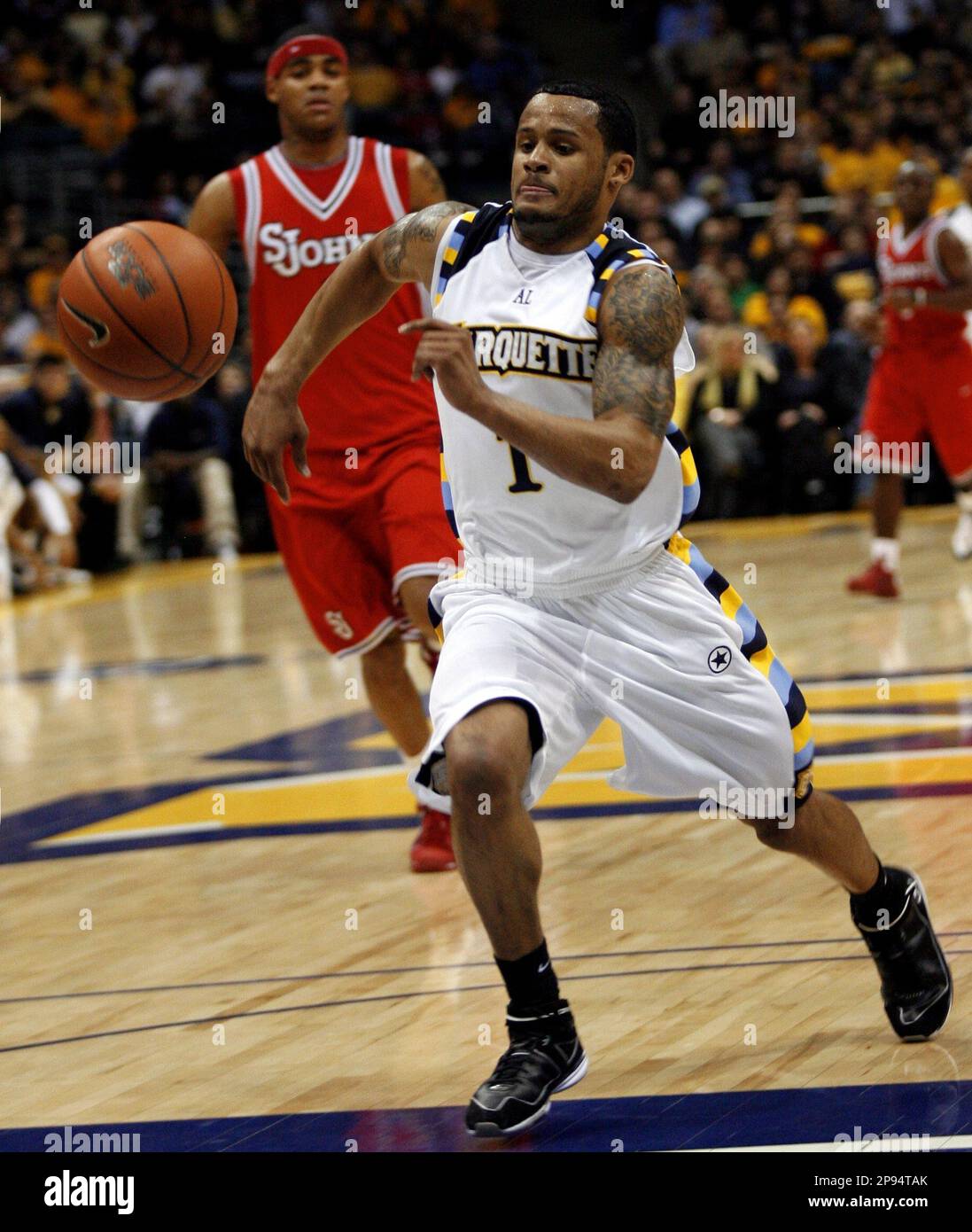 Marquette's Dominic James, right, tries to run down a loose ball ...