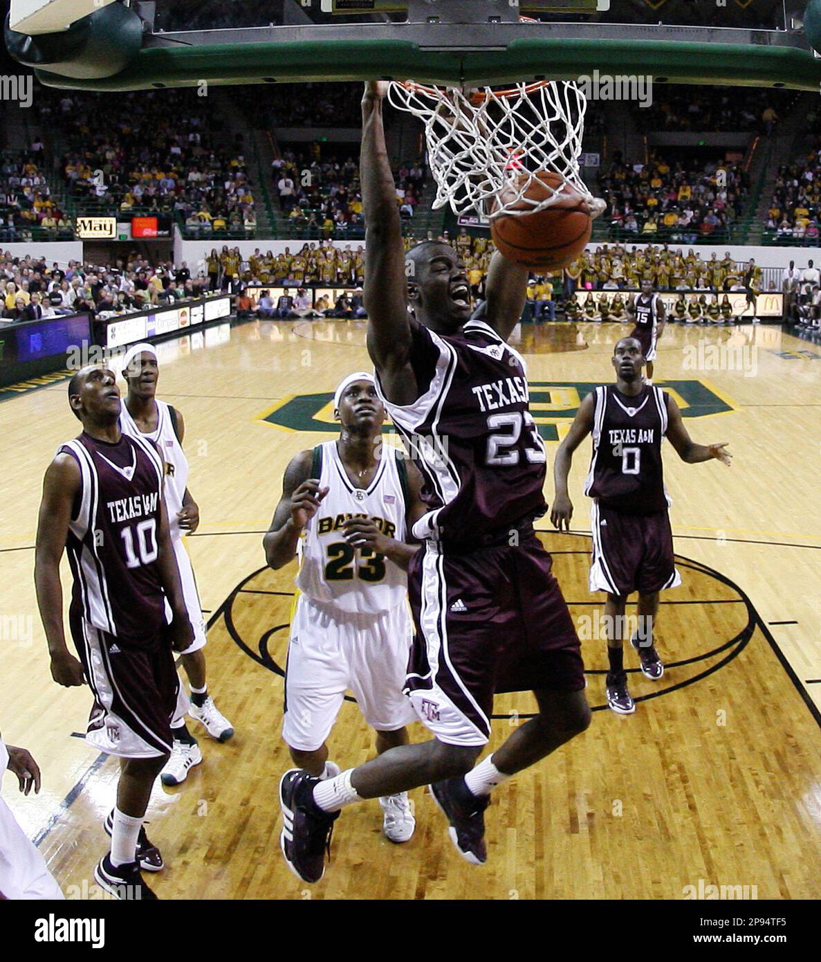 Texas A&M Josh Carter (23) scores past Baylor Kevin Rogers (23) in the ...
