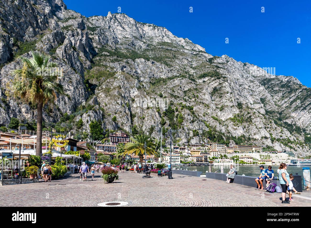 Promenade and center in Limone sul Garda, behind the mountain Cima di ...