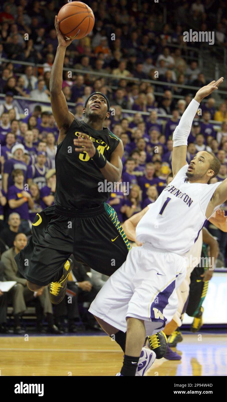 Oregon's Kamyron Brown, left, drives to the basket as Washington's ...