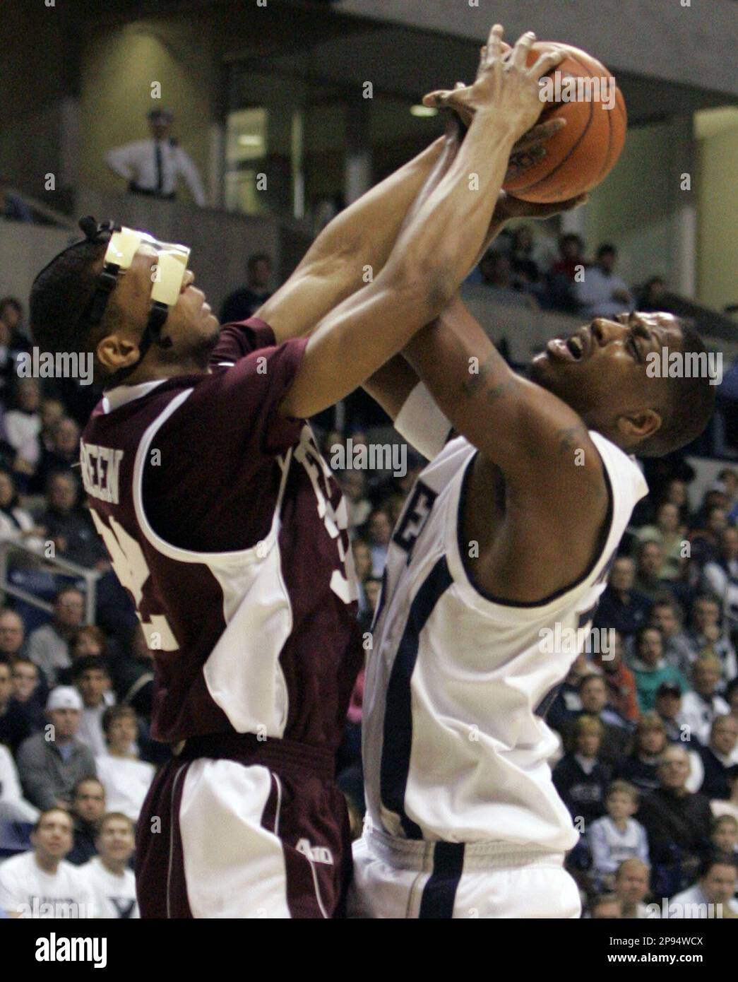 Fordham forward Jacob Green, left, forces a jump ball against Xavier ...