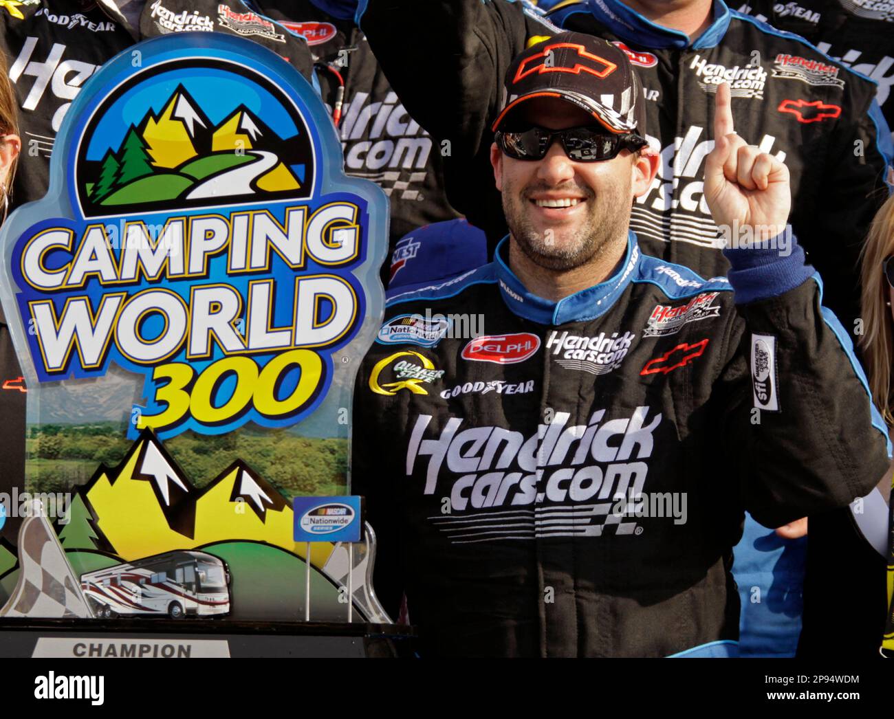 Driver Tony Stewart poses with the trophy after winning the Camping ...