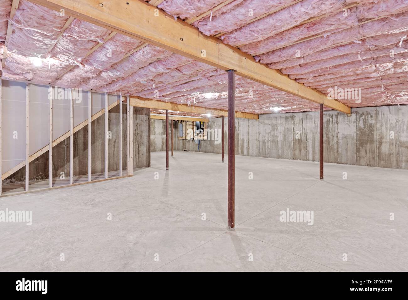 The unfinished home basement with the ceiling and concrete walls under ...