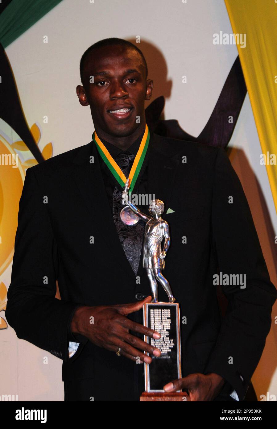Champion Jamaican sprinter Usain Bolt holds his Sportsman of the Year ...