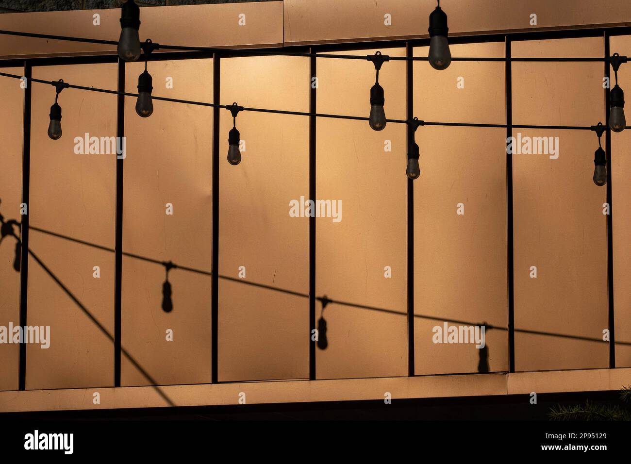 Outdoor lighting reflected on golden panels Stock Photo - Alamy