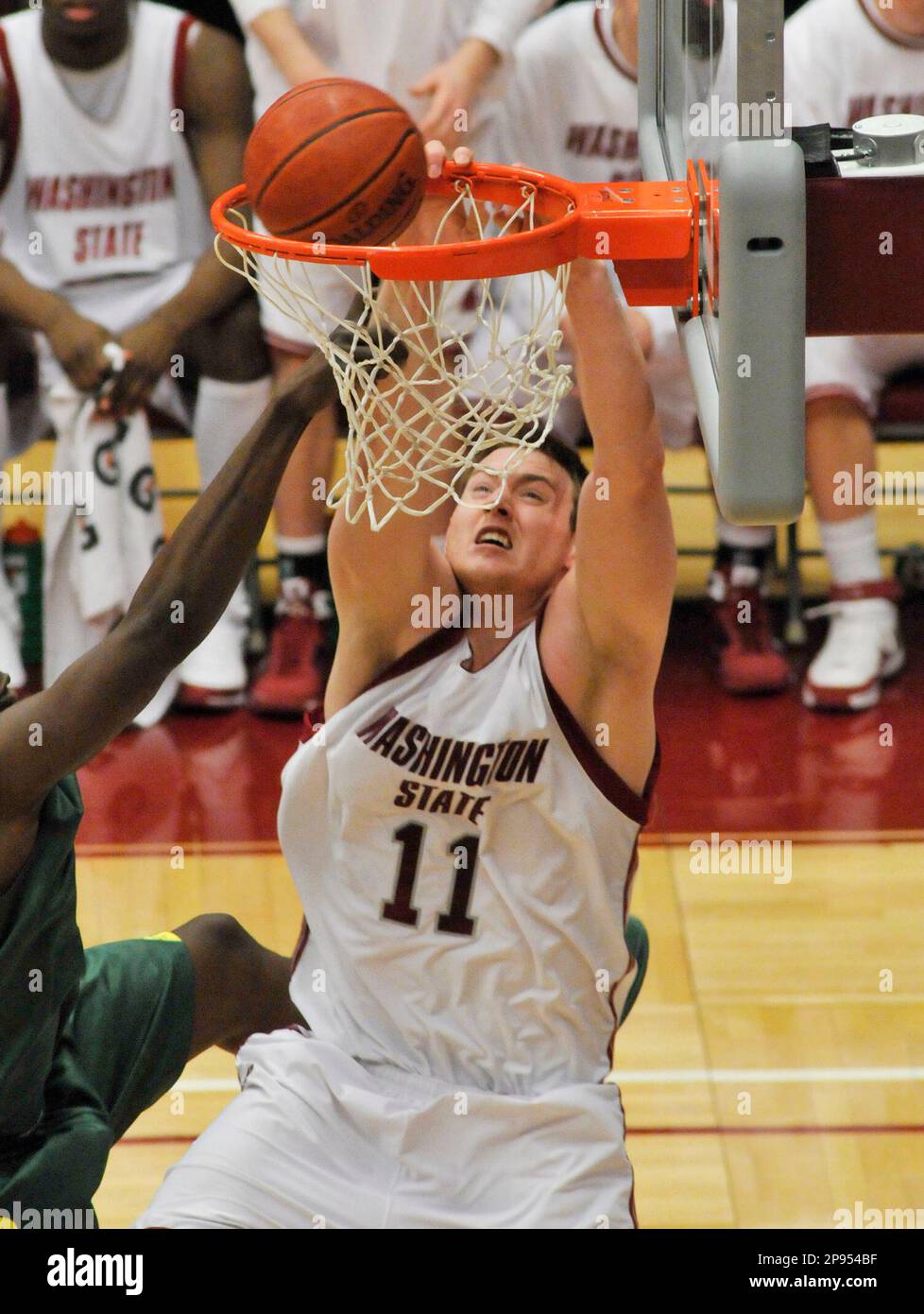 Washington State's Aron Baynes attempts a dunk but is fouled by Oregon ...