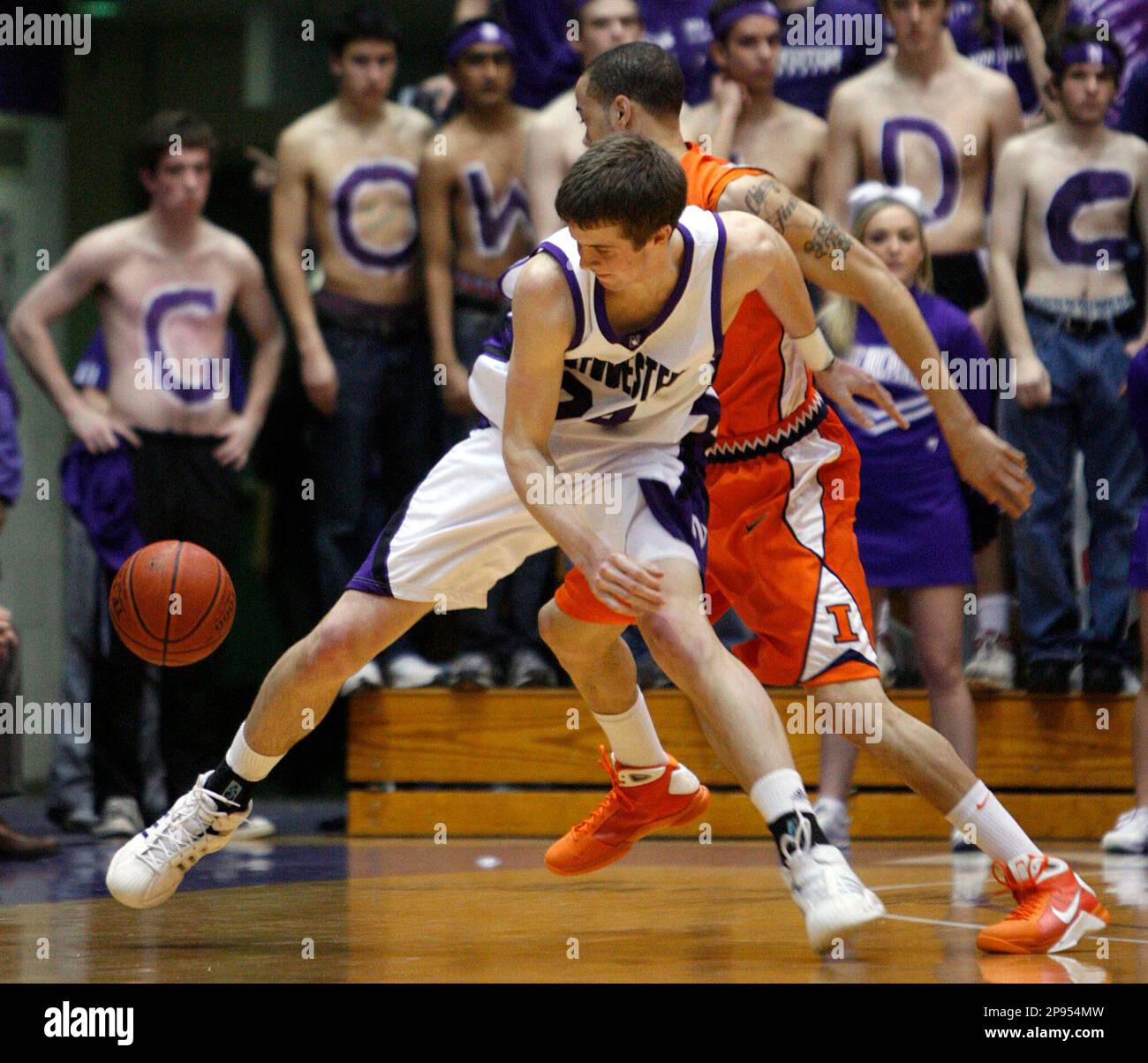 Northwestern's John Shurna, front, and Illinois' Calvin Brock scramble ...