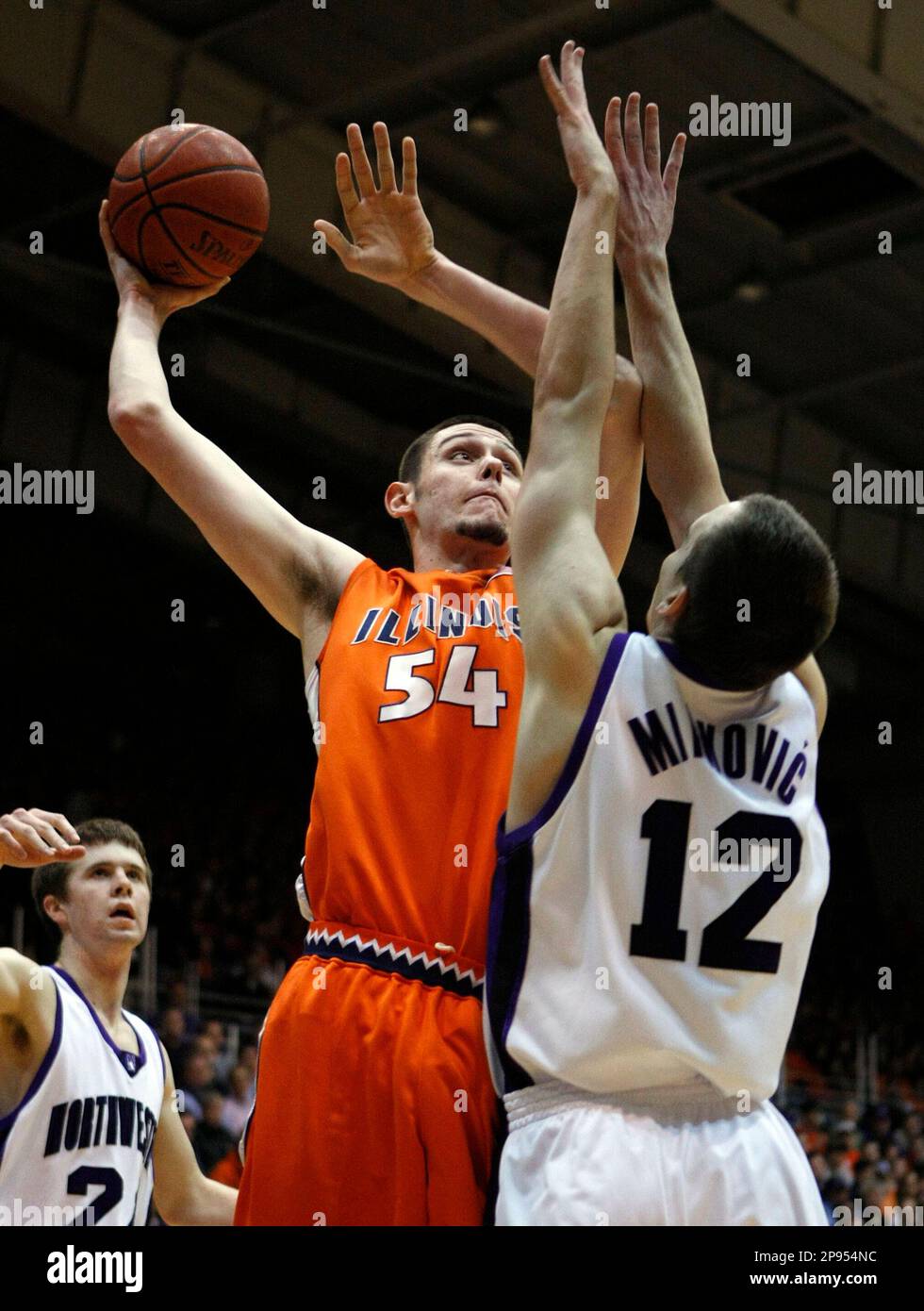 Illinois's Mike Tisdale(54) scores over Northwestern's Luka Mirkovic ...