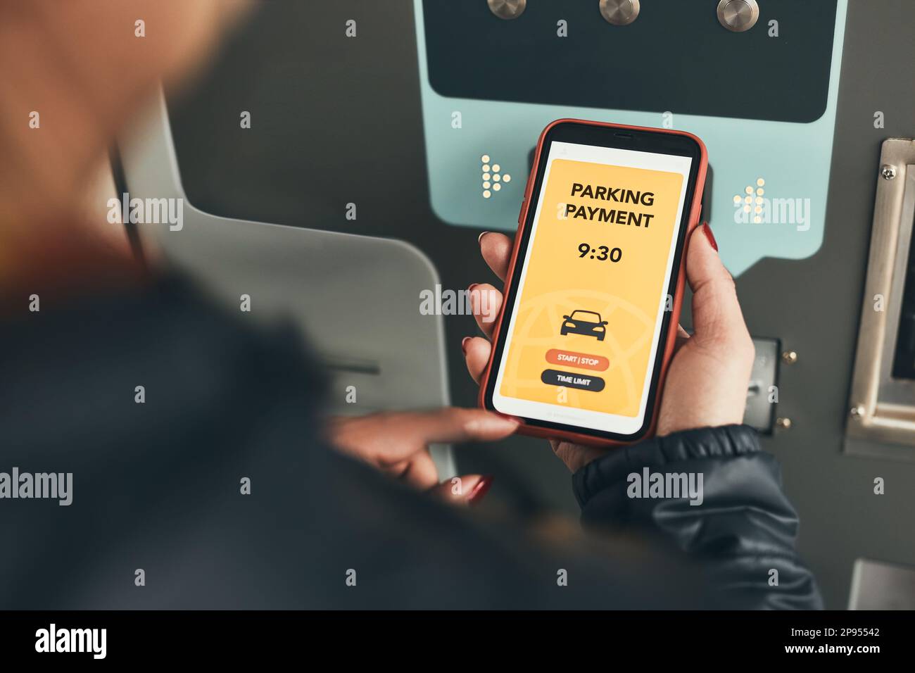 Woman paying for parking ticket at car parking payment machine using ...