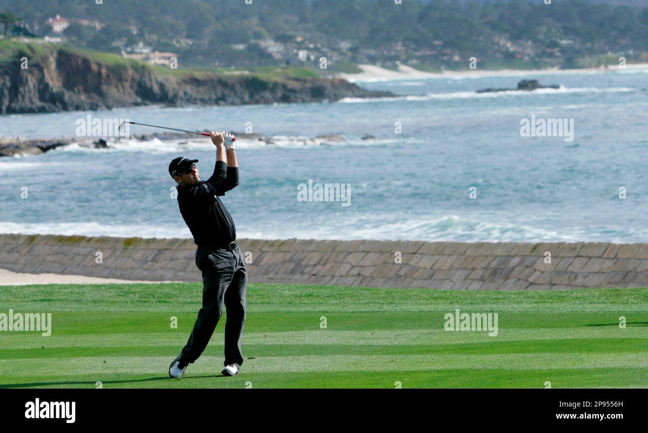 Rich Beem hits from the 18th fairway at Pebble Beach golf links during ...