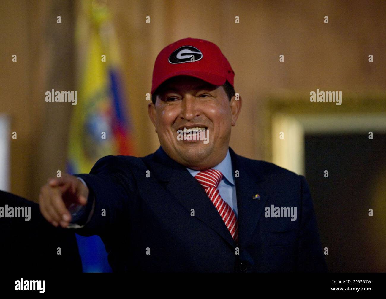 Venezuela's President Hugo Chavez gestures as he wears a hat of the ...