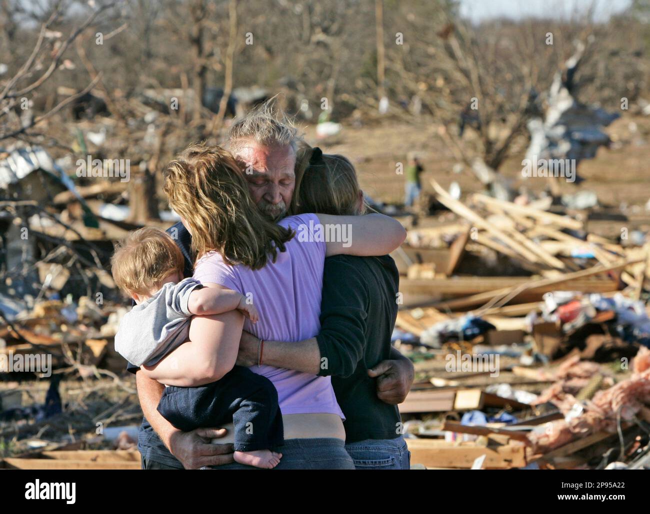 Dennis Parker, center, is embraced by his daughter Dondria Hickman ...