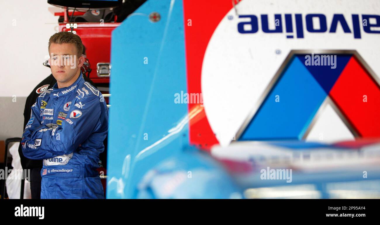 NASCAR driver AJ Allmendinger stands by his car as his team works on it ...