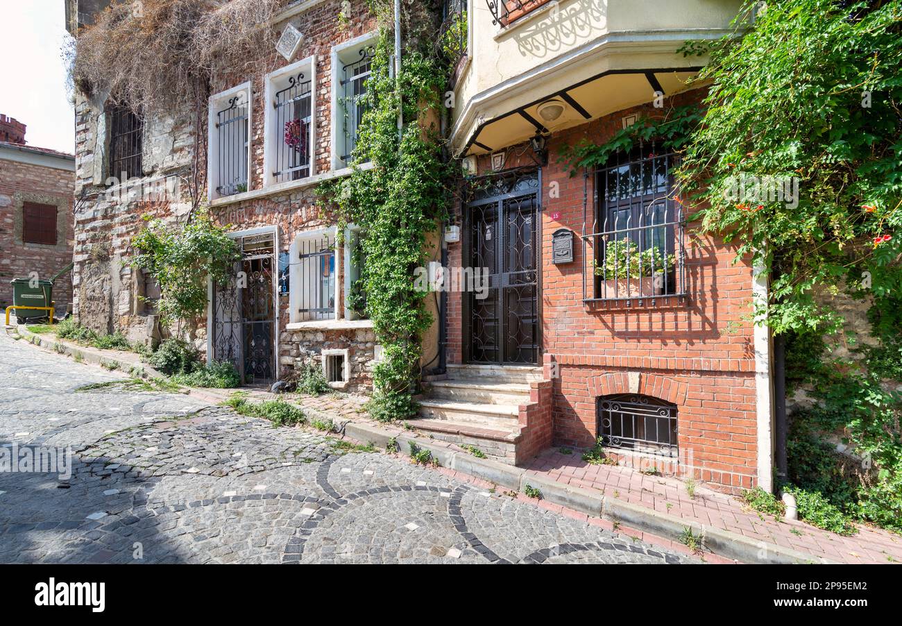 Cobblestone alley with beautiful old traditional red bricks houses and ...