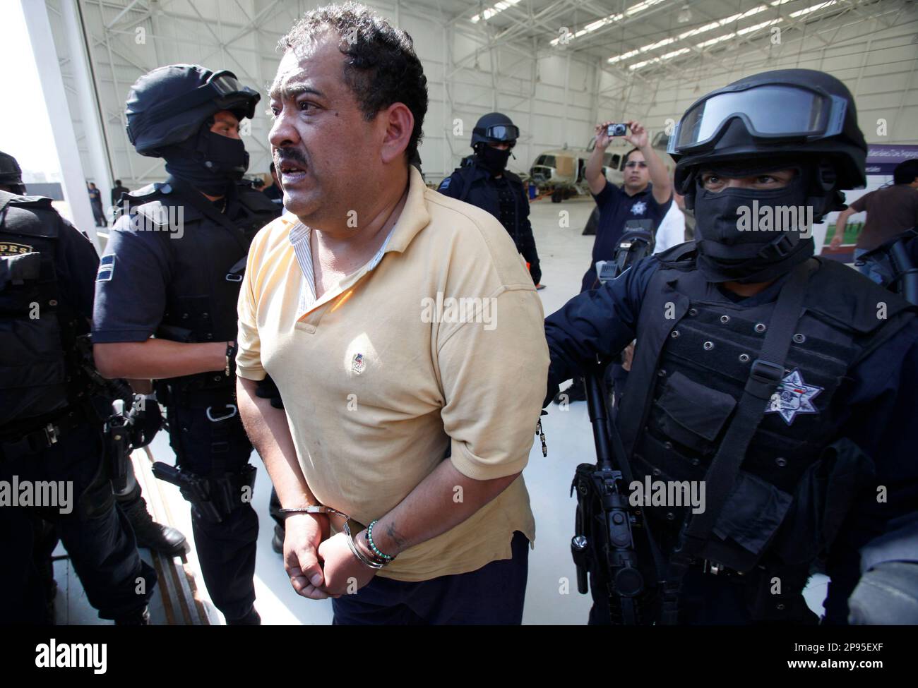 Alberto Martin Alamillo, center, suspected leader of a crime gang ...