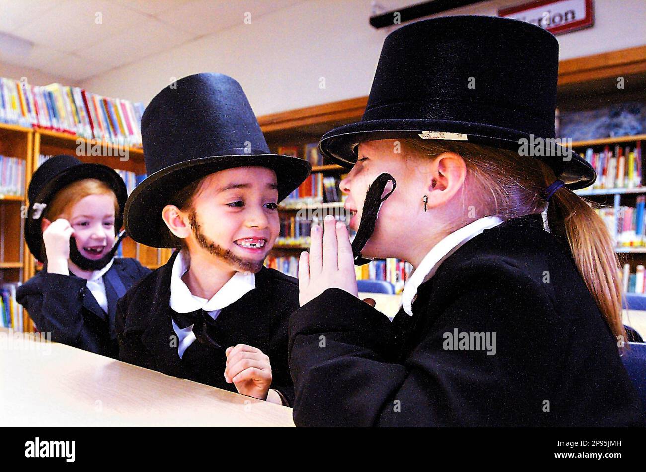 Abraham Lincoln look-alikes Abbey Gegen, 6, right, whispers a secret to ...