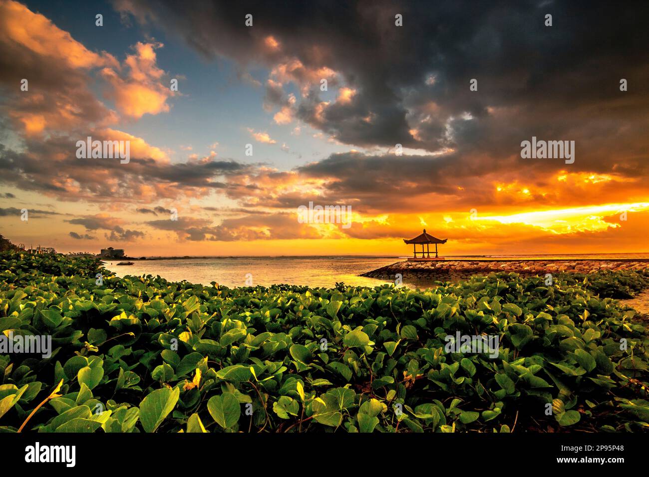 Sunrise on Sanur beach in Bali, temple / pagoda in the sea as a ...