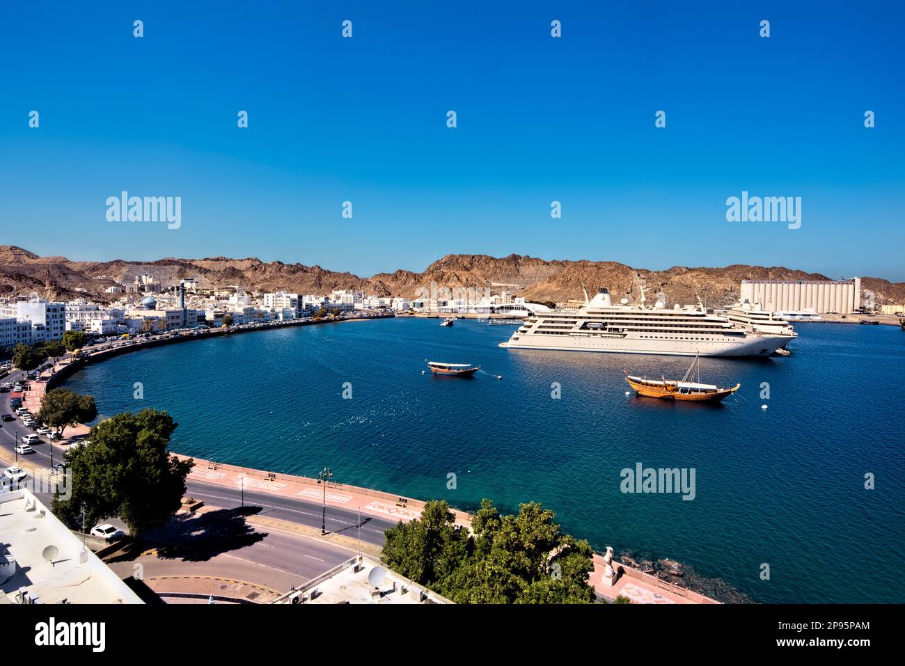 Cruise ship and traditional dhows in the Mutrah Harbor, Muscat, Oman ...