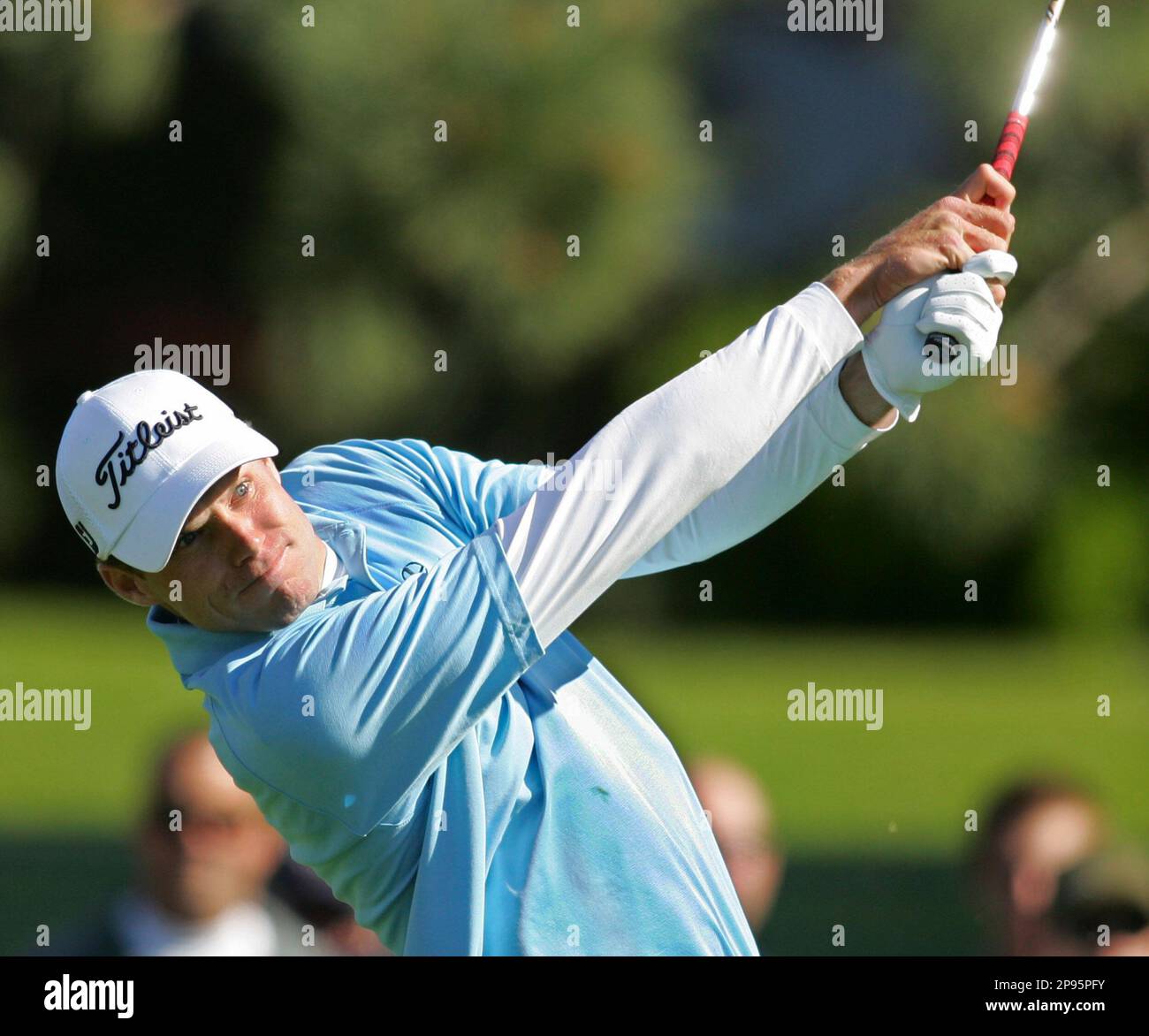 Nick Watney follows through with his tee shot on the 11th hole at ...
