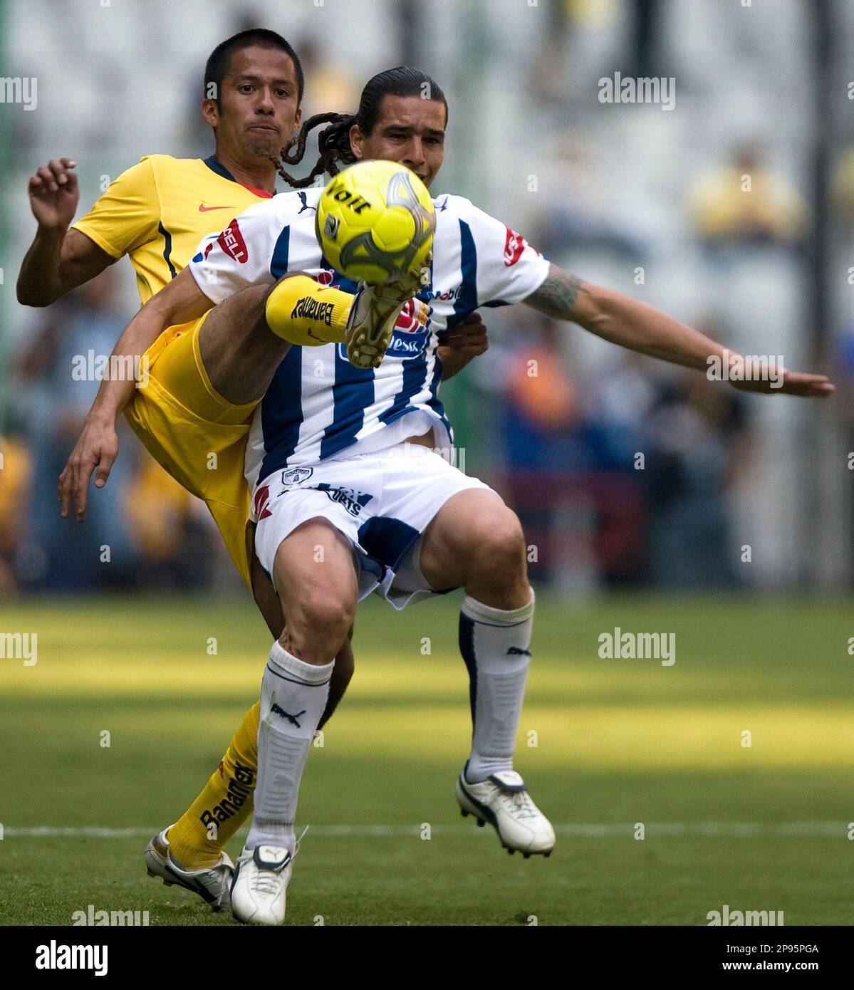 Pachuca's Ulises Mendivil, front, fights for the ball with America's ...