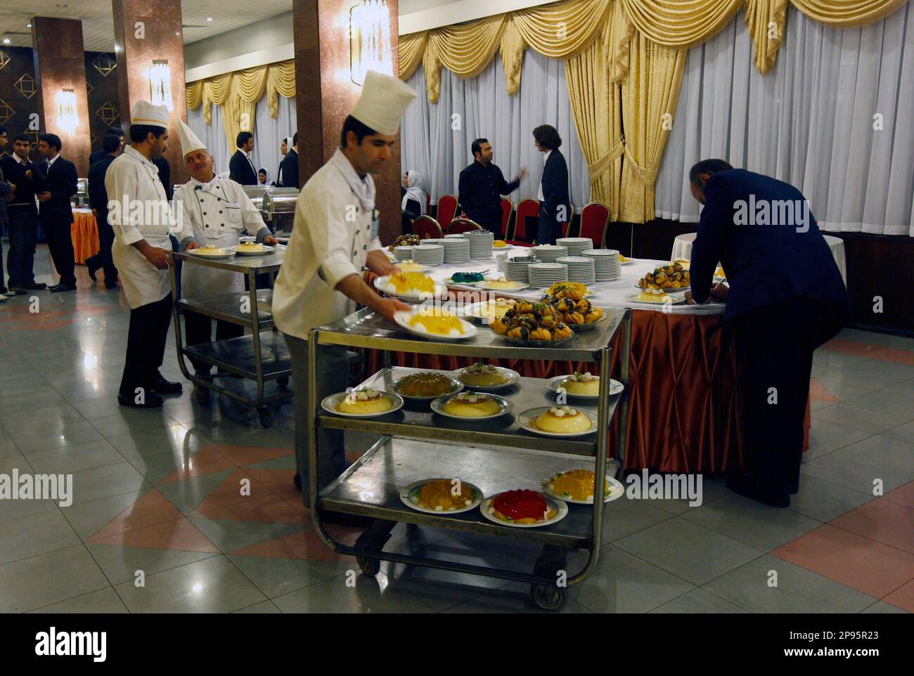 Iranian chefs prepar dinner for guests during the gathering of minority ...