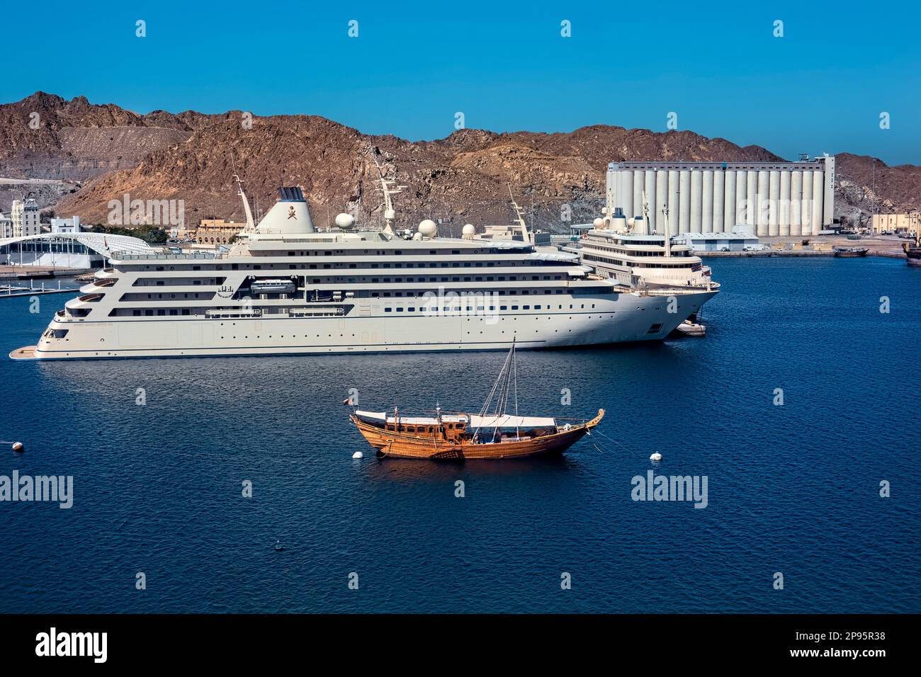 Cruise ship and traditional dhow in the Mutrah Harbor, Muscat, Oman ...