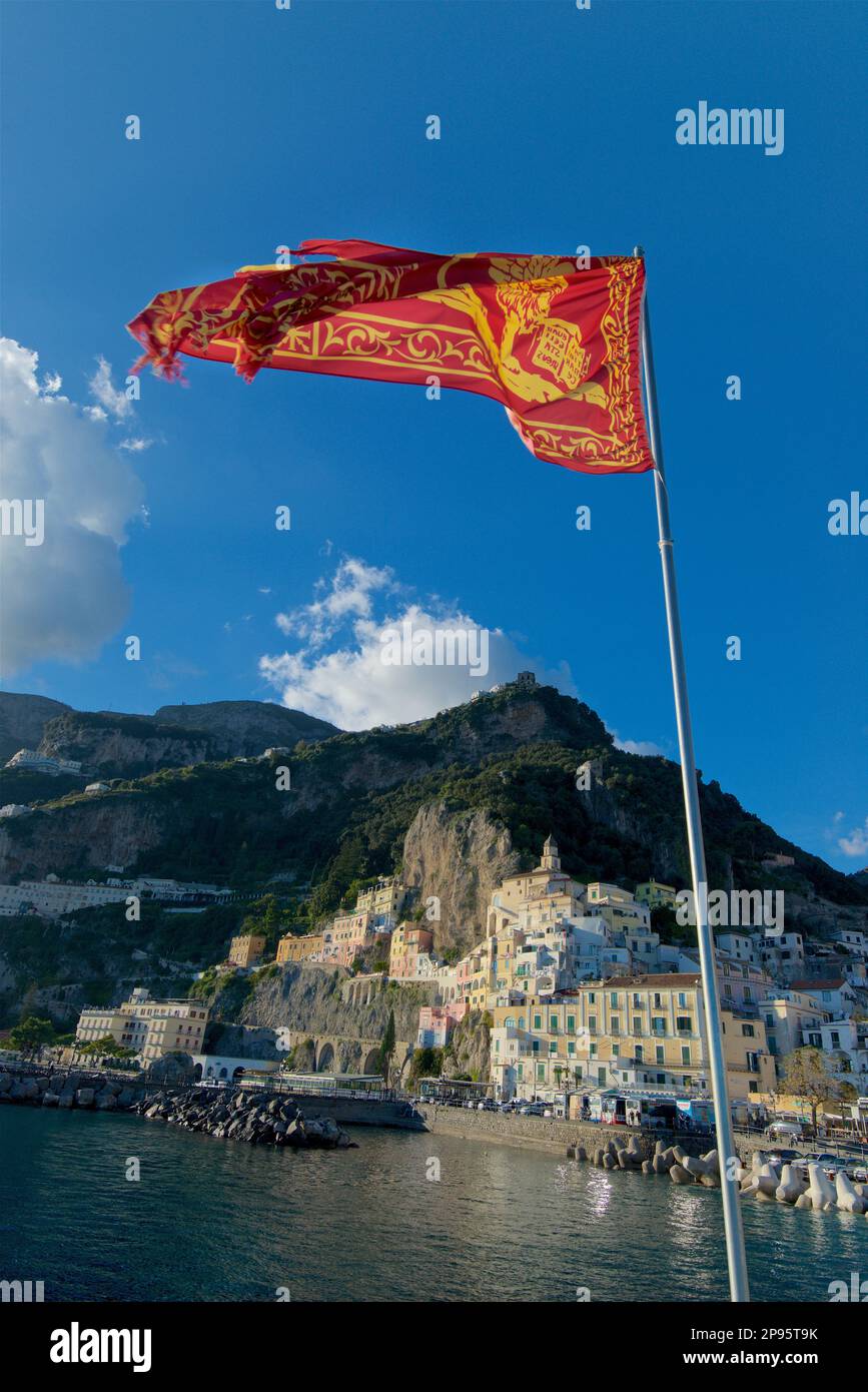 Venetian flag flying on a flagpole on the main jetty at Amalfi, Salerno ...
