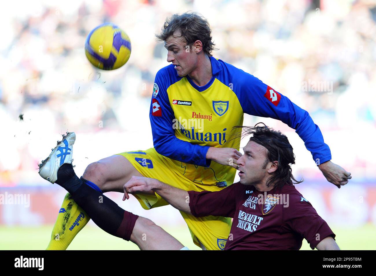 Torino's Paolo Zanetti, right, fights for the ball with Chievo's Luca ...