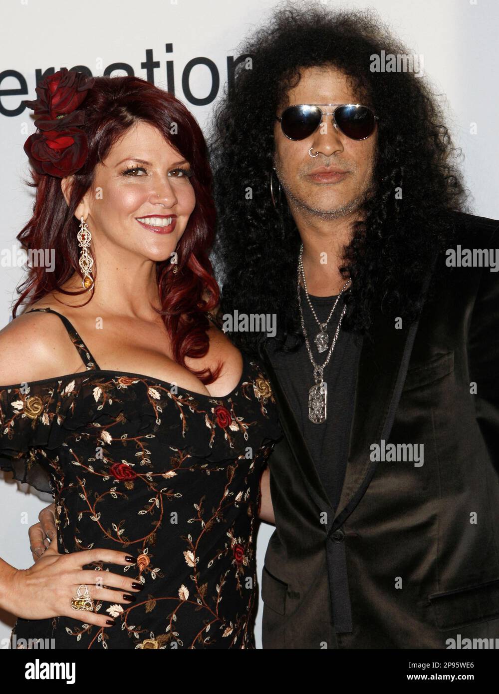 Perla Hudson, left, and Slash arrive at the Clive Davis pre-Grammy ...