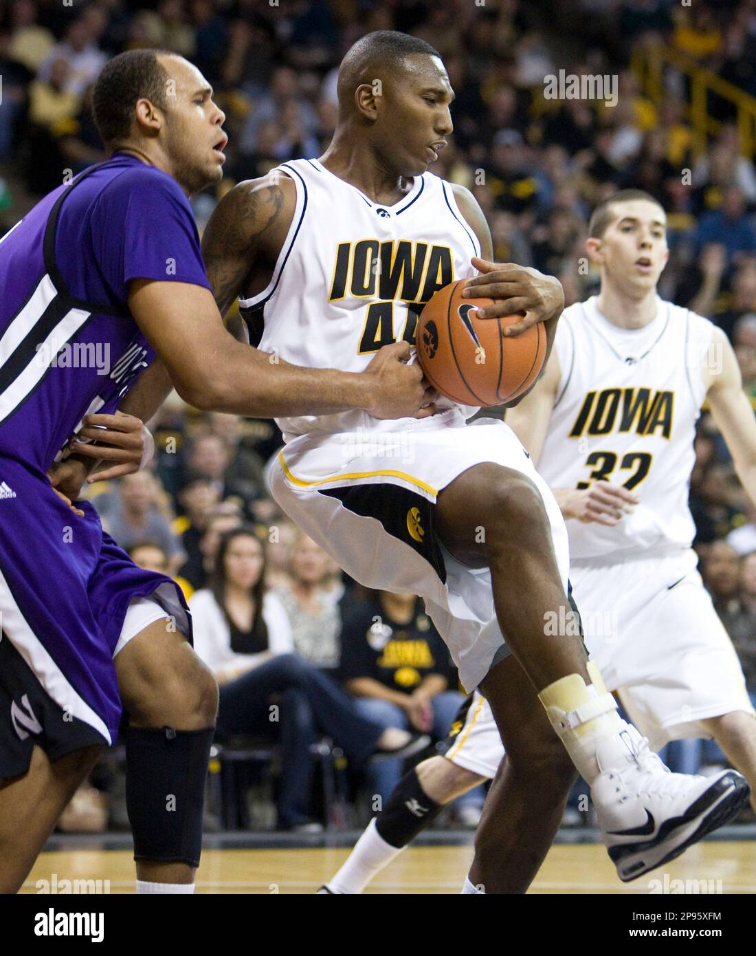 Iowa's Cyrus Tate (44) fights for a rebound with Northwestern's Kyle ...