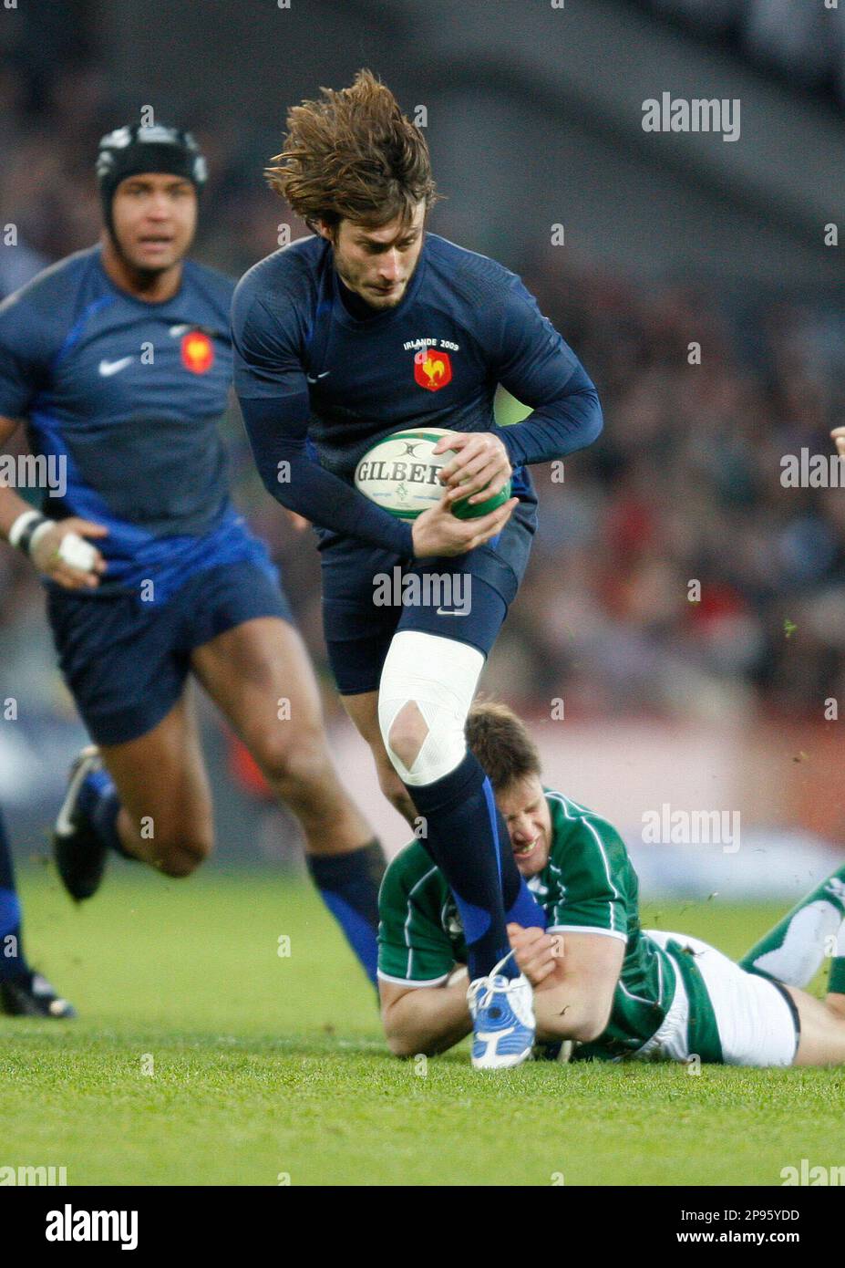 France's Maxime Medard is tackled by Ireland's Ronan O'Gara in the Six ...
