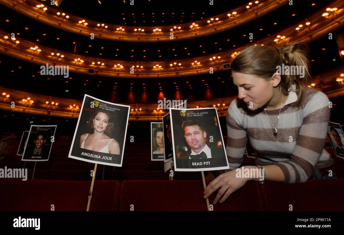 A British Academy Film & Television Awards, BAFTA, worker arranges face ...