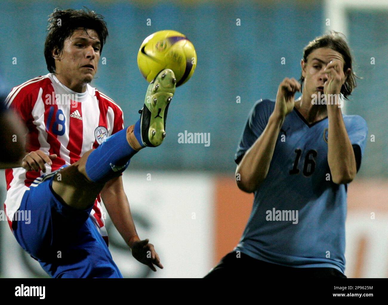 Paraguay's Freddy Coronel, left, fights for the ball with Uruguay's ...