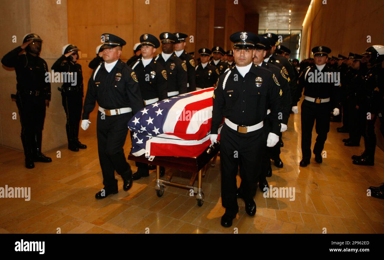 Honor guard wheels the casket of Culver City police Sgt. Curtis Massey ...