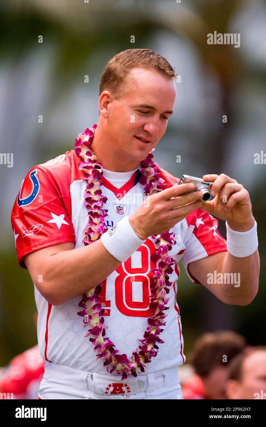 Indianapolis Colts quarterback Peyton Manning looks at the photographs ...