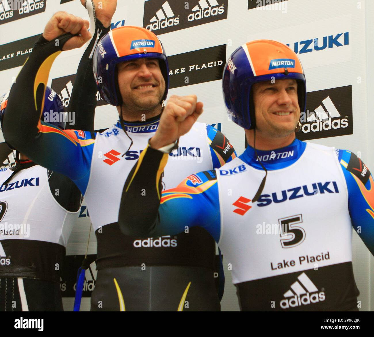 USA's Mark Grimmette, left, and Brian Martin react on the podium after ...